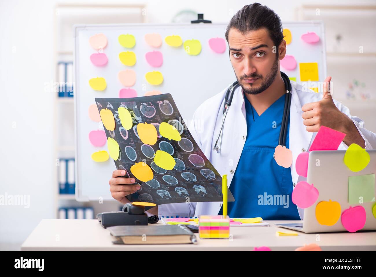 Young medic in conflicting priorities concept Stock Photo - Alamy
