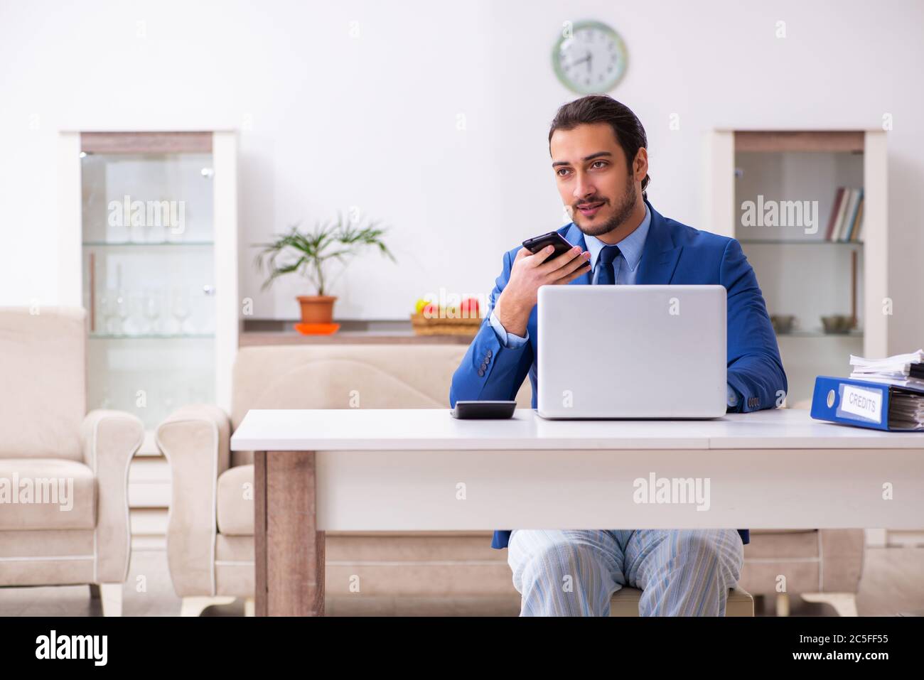 Young employee working from house in self-isolation concept Stock Photo ...
