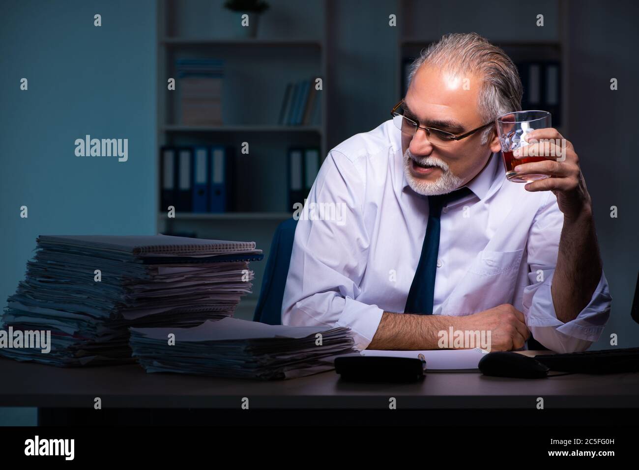 Old employee working late in the office Stock Photo - Alamy