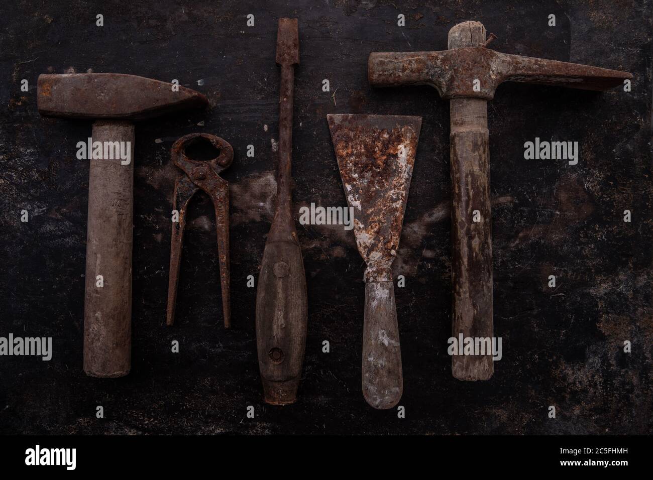 old tools, hammer, chisel, spatula measuring tape and brushes greasy ...
