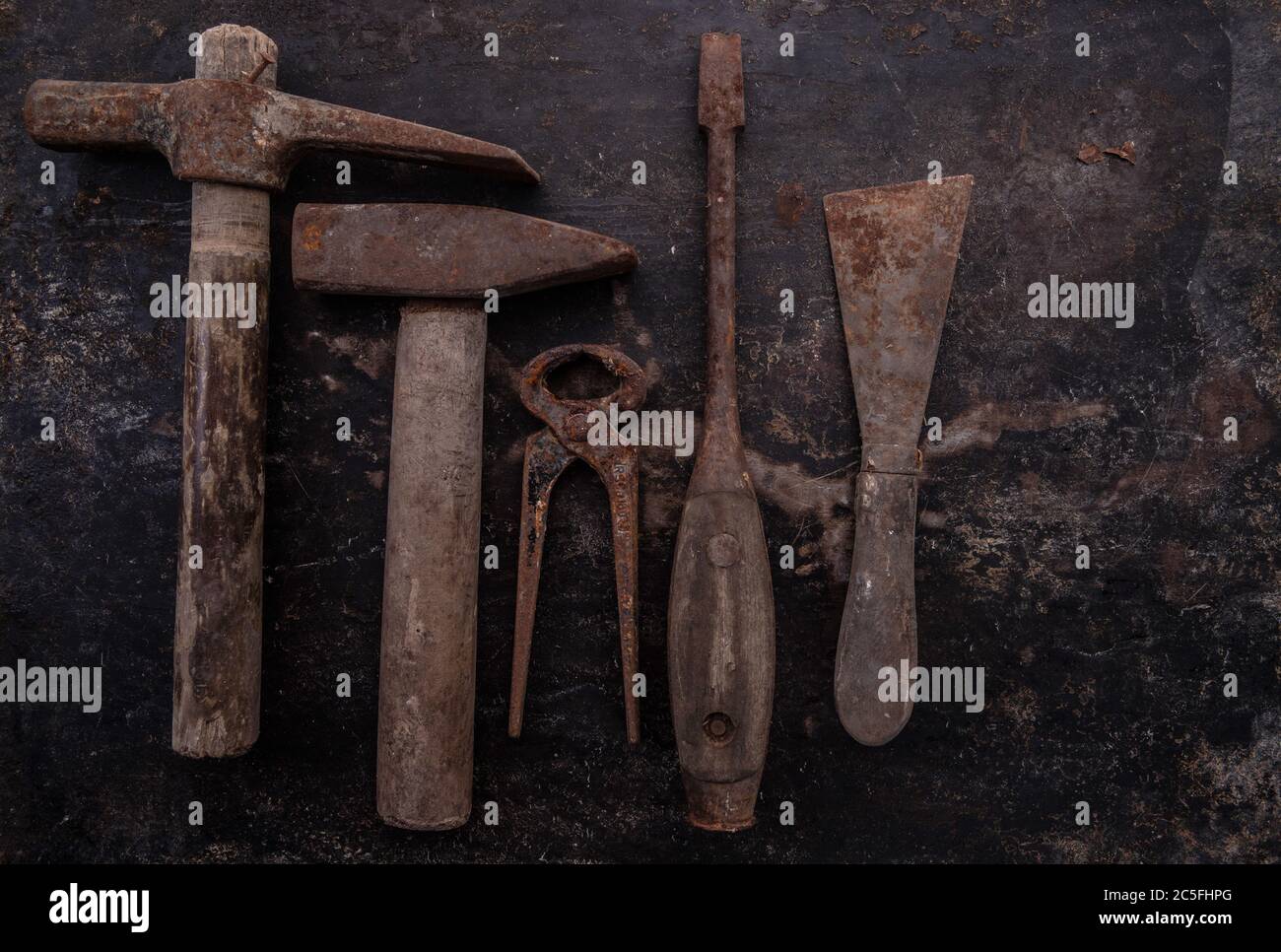 old tools, hammer, chisel, spatula measuring tape and brushes greasy ...