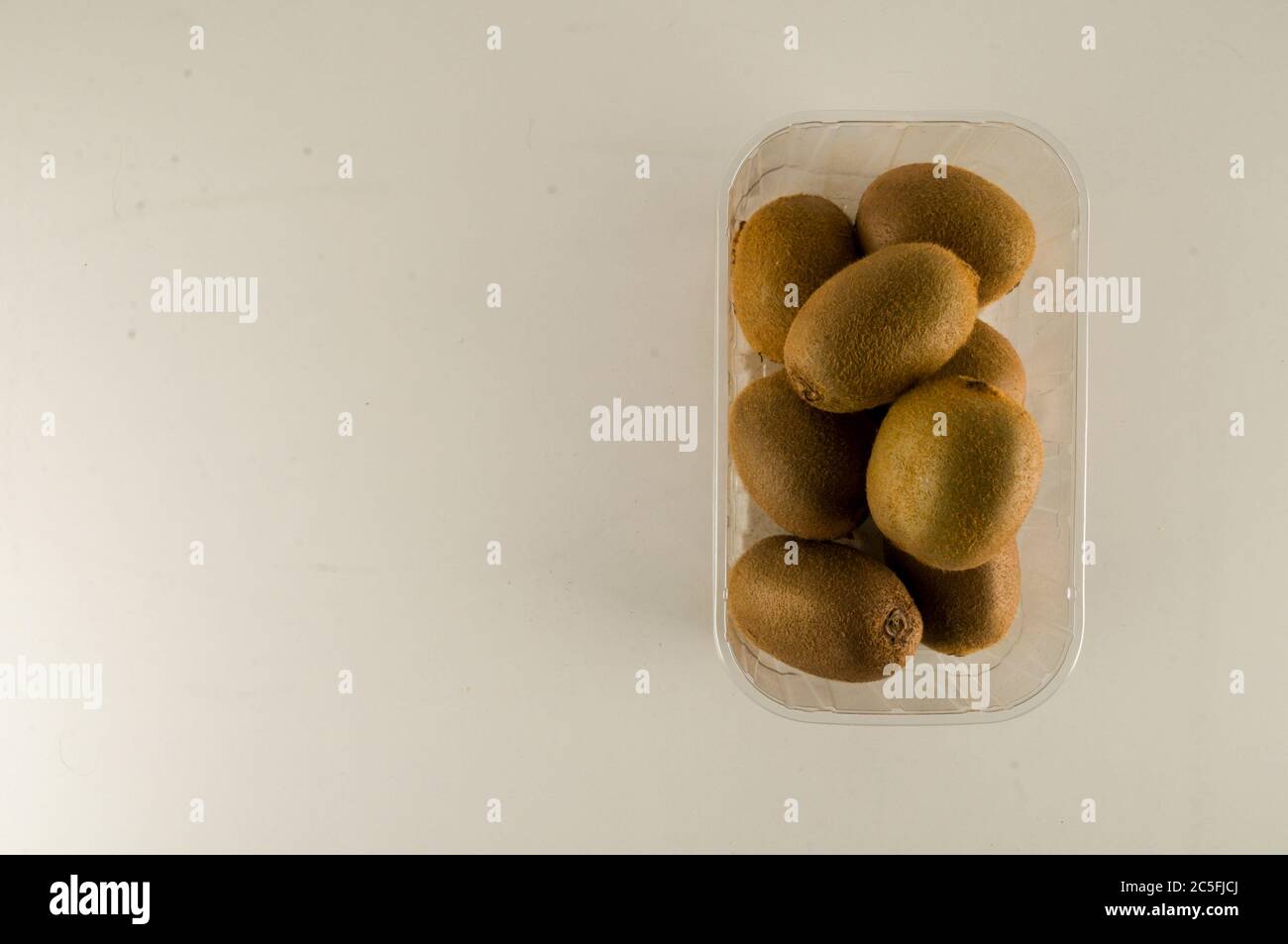 Kiwi in a box isolated on white background Stock Photo - Alamy