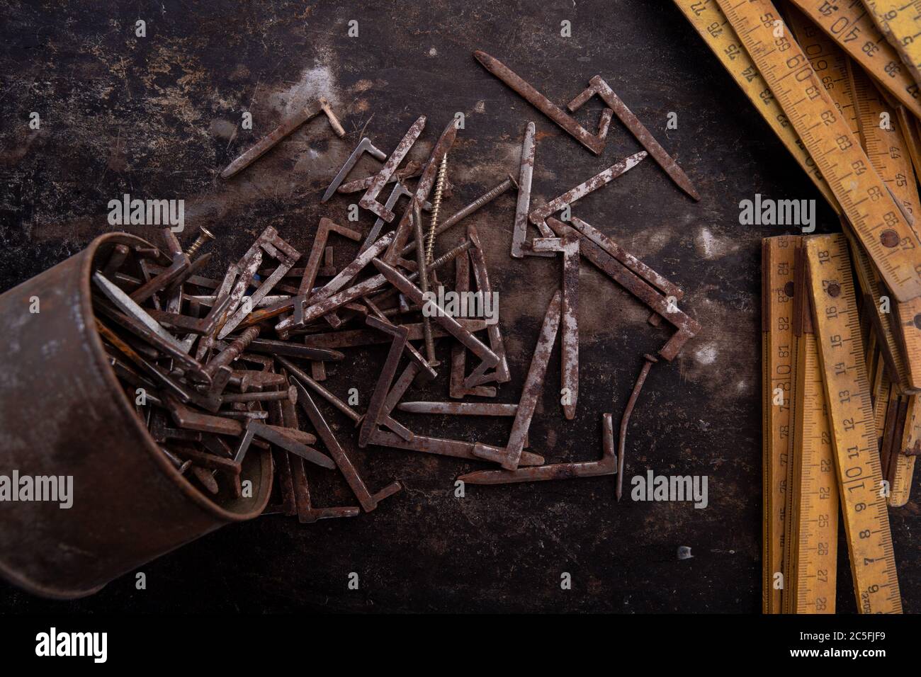 old nuts, screws and nails greasy and dirty heavily rusted lie on a ...