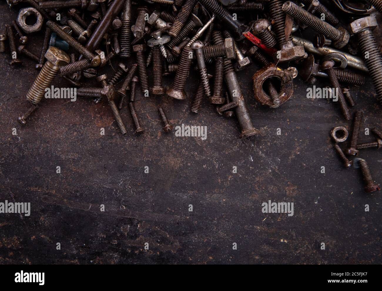 old nuts, screws and nails greasy and dirty heavily rusted lie on a ...
