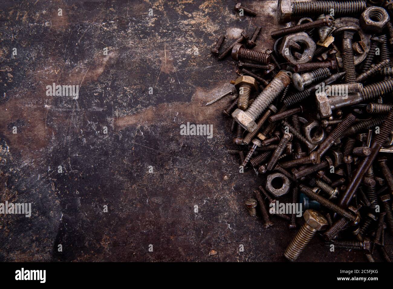 old nuts, screws and nails greasy and dirty heavily rusted lie on a ...