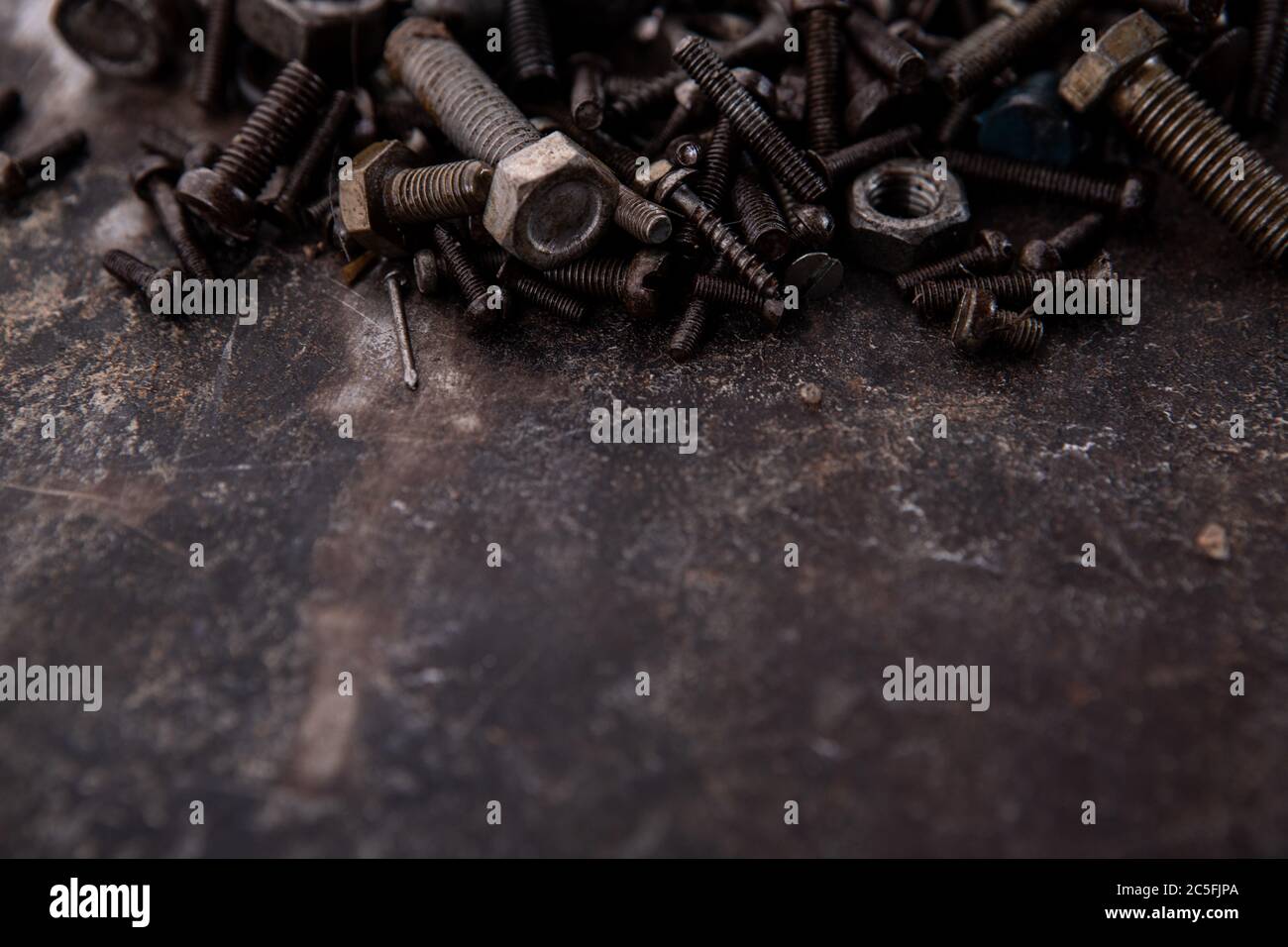 old nuts, screws and nails greasy and dirty heavily rusted lie on a ...