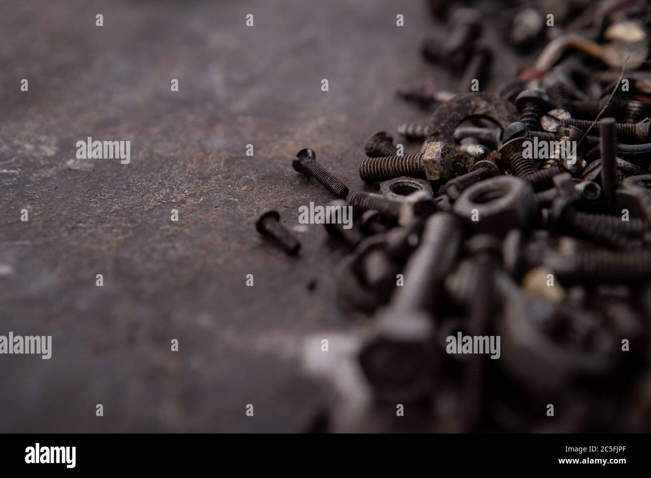 old nuts, screws and nails greasy and dirty heavily rusted lie on a ...
