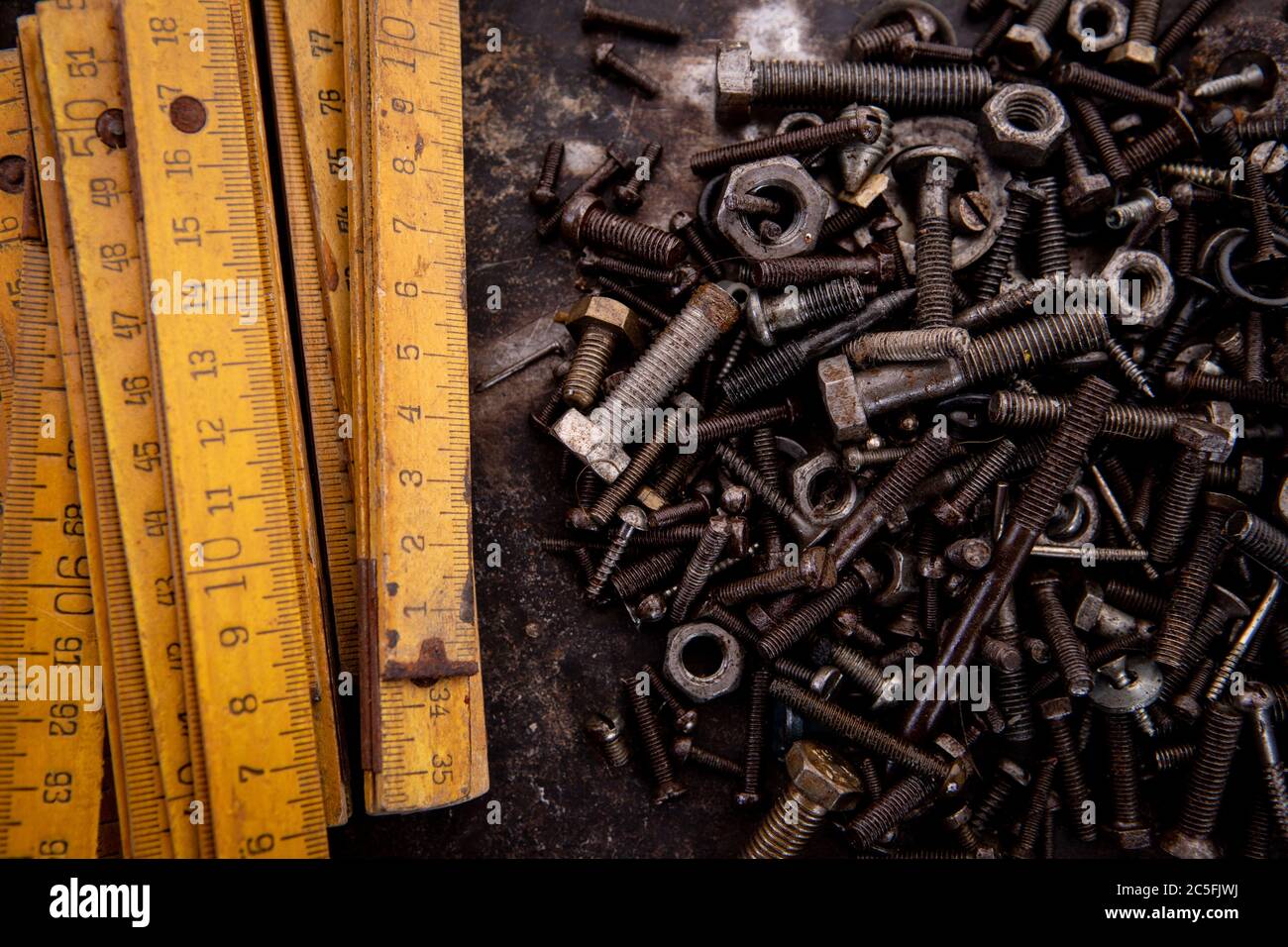 old nuts, screws and nails greasy and dirty heavily rusted lie on a ...