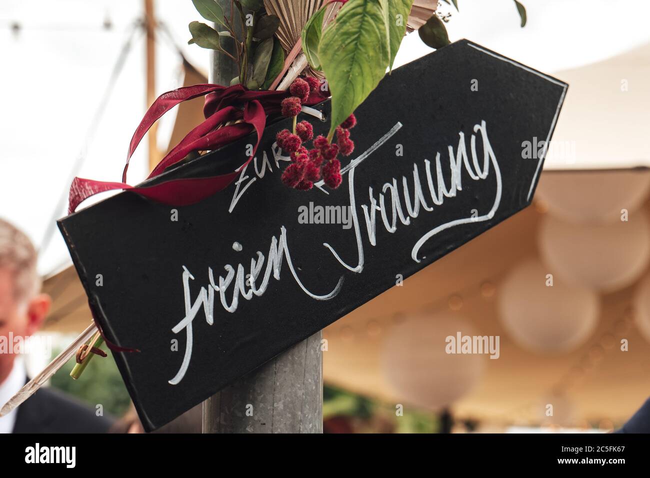 Black label with german inscription for guests at wedding venue. Sign ...