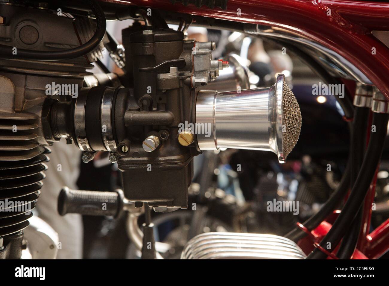 close up detail of a carburetor and air intake on a motorbike engine ...