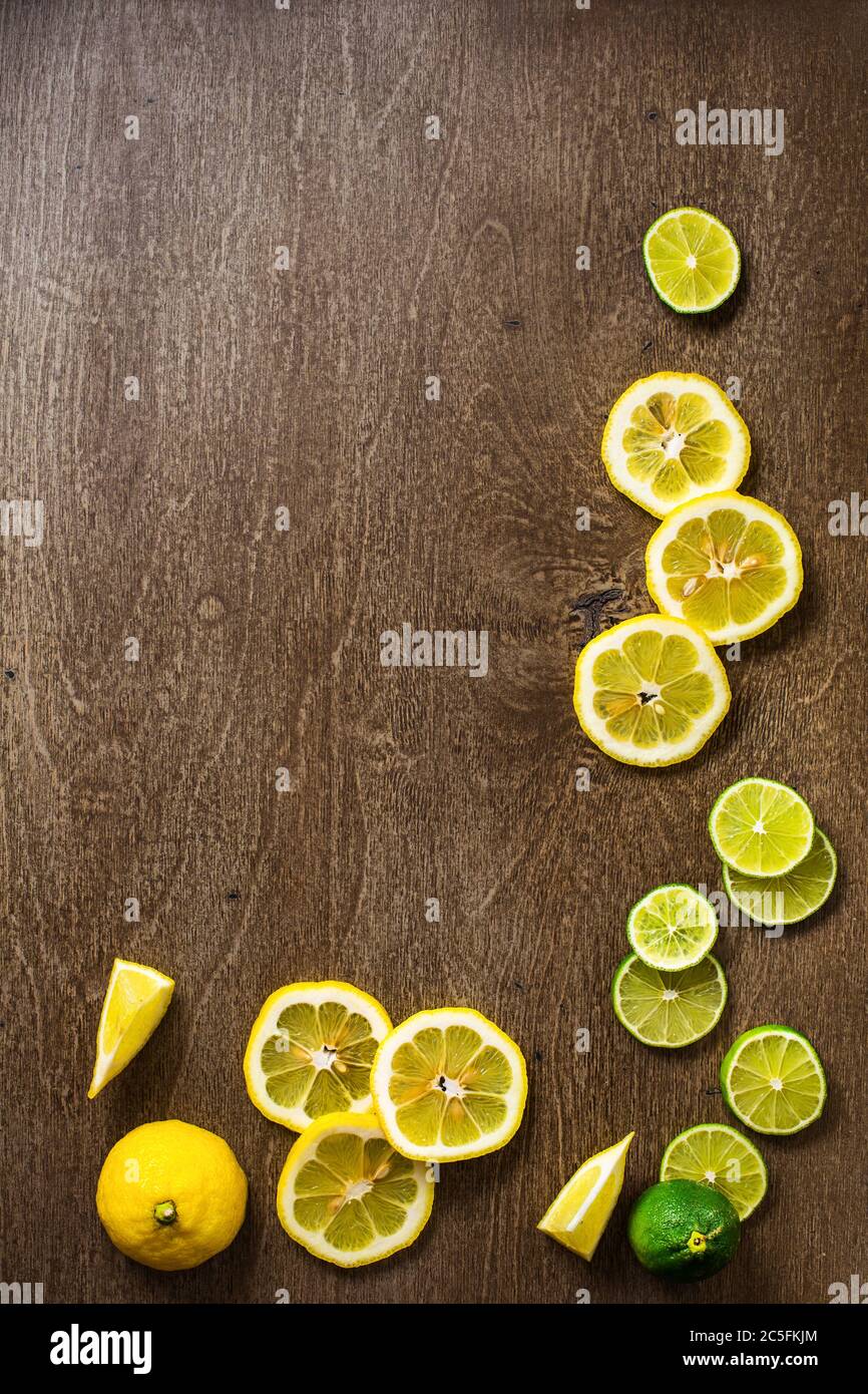 sliced lemon, lime on slate and wooden counter top background Stock ...