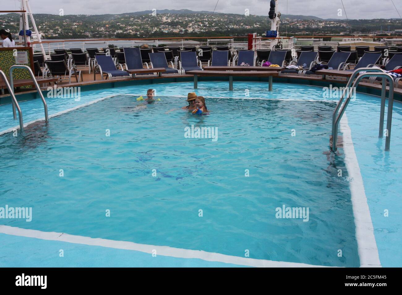Cruise ship's pool for vacationers on their cruise, having fun at sea ...