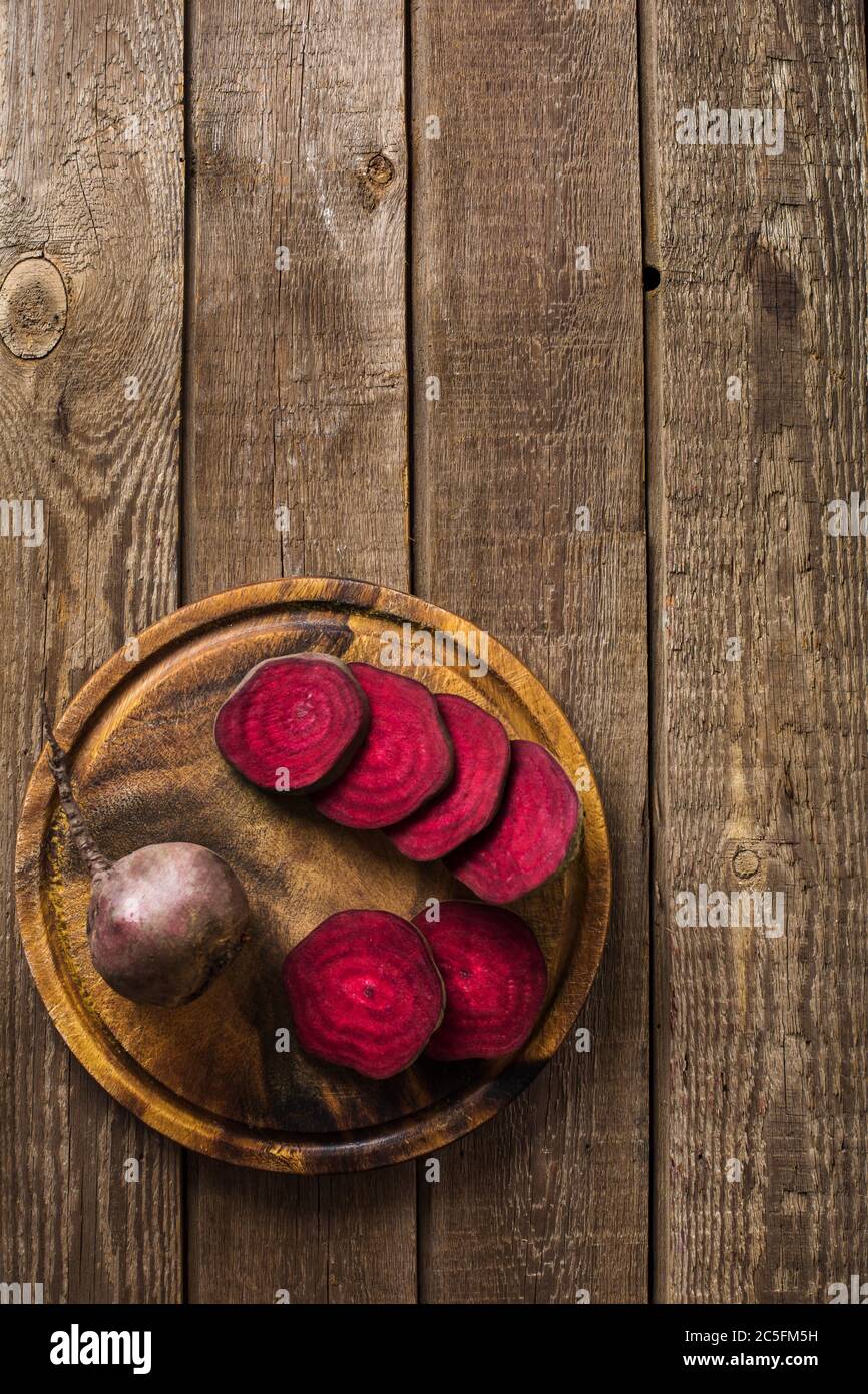 sliced on beetroot slate and wooden counter top background Stock Photo ...