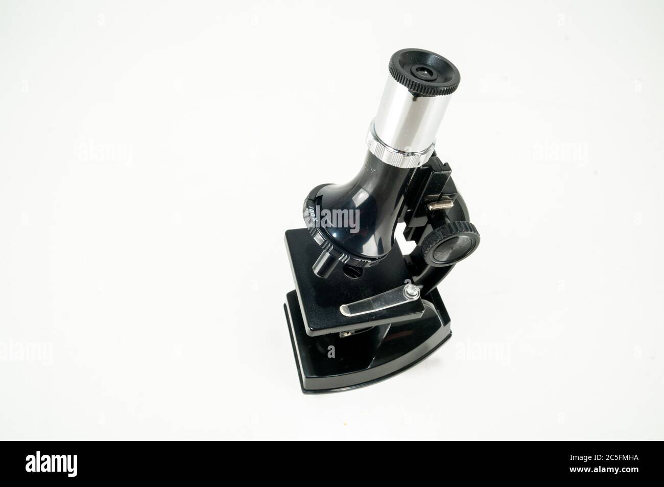 An old scientific microscope toy isolated on white Stock Photo - Alamy