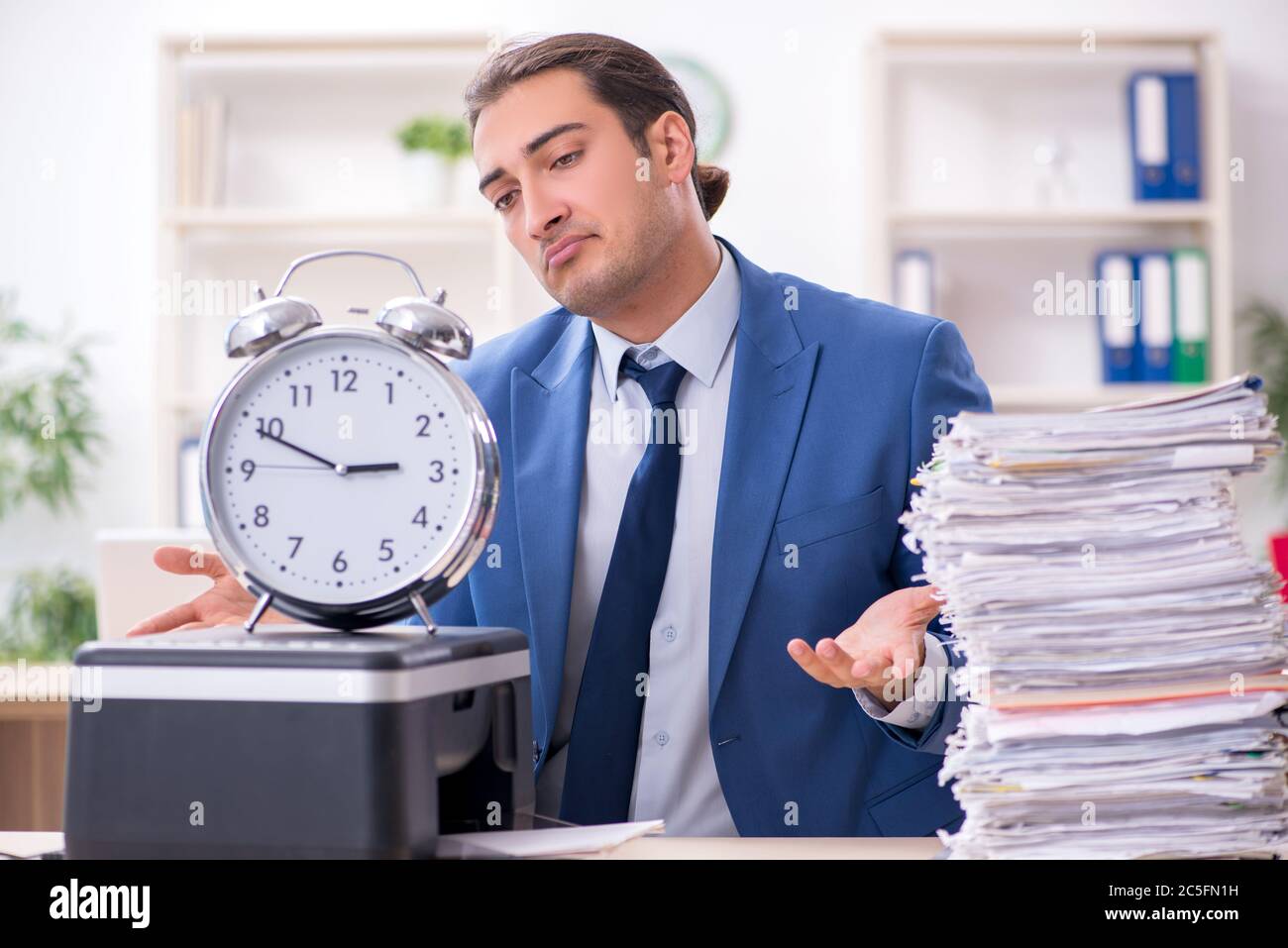 Young employee making copies at copying machine Stock Photo - Alamy
