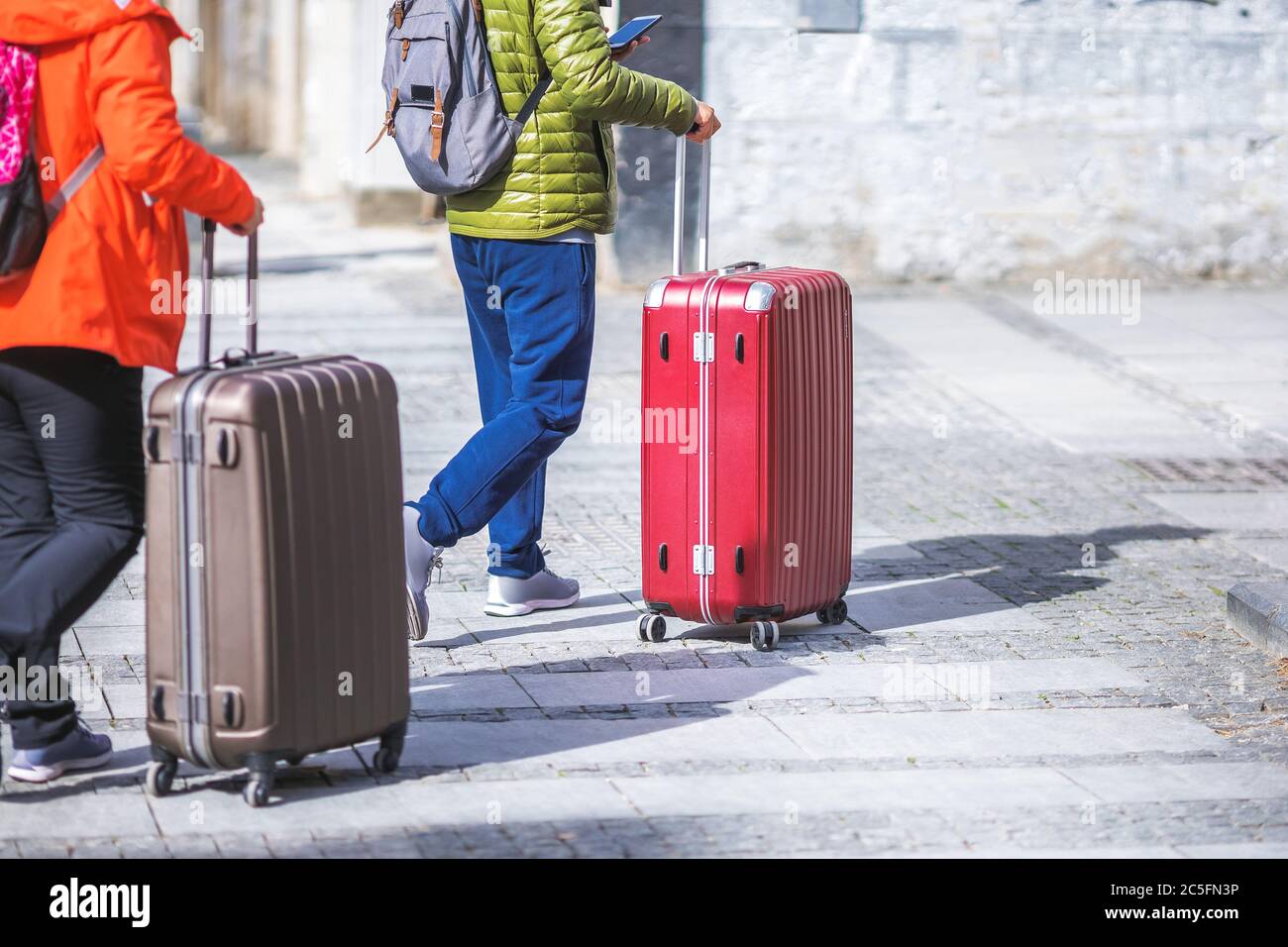 tourists walking with suitcases on the street Stock Photo - Alamy