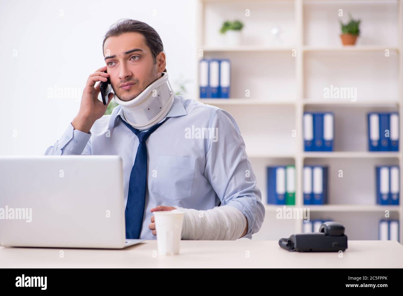 Injured male employee at work after accident Stock Photo - Alamy