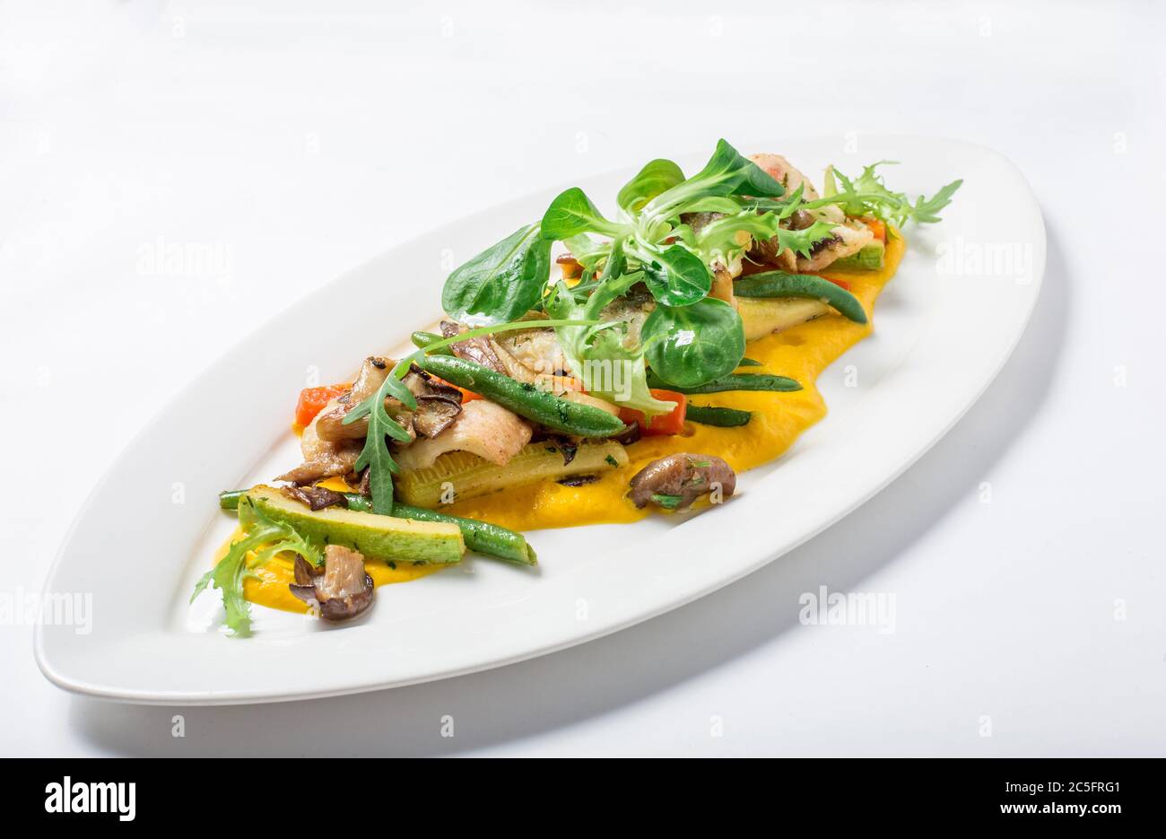 Baked fish King clip with vegetables and sauce. Close-up Stock Photo ...
