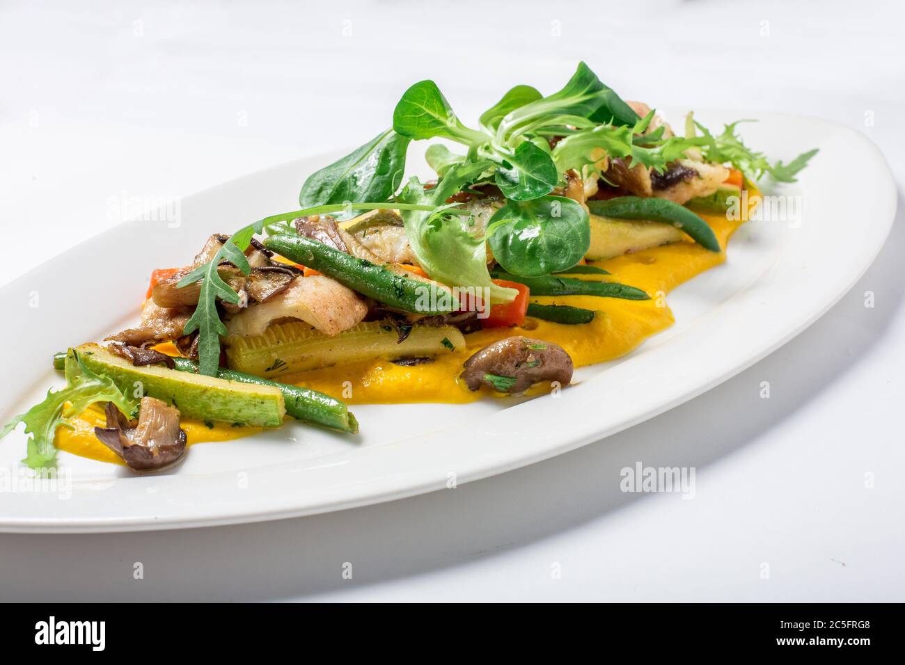 Baked fish King clip with vegetables and sauce. Close-up Stock Photo ...