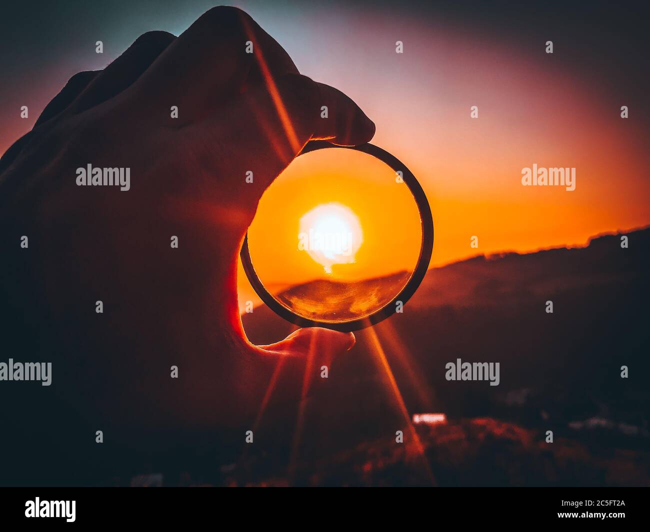 Taking photos of sunset through the camera filter inside nature Stock ...