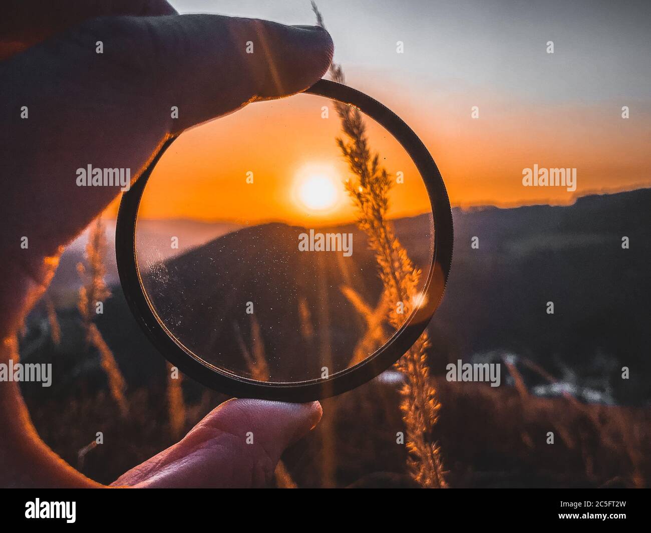 Taking photos of sunset through the camera filter inside nature Stock ...
