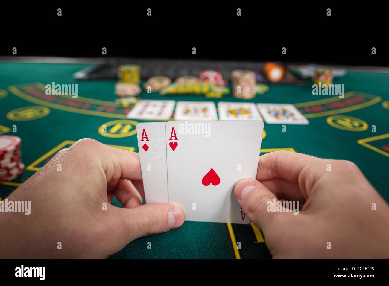 Male poker player holding the of two cards aces Stock Photo - Alamy