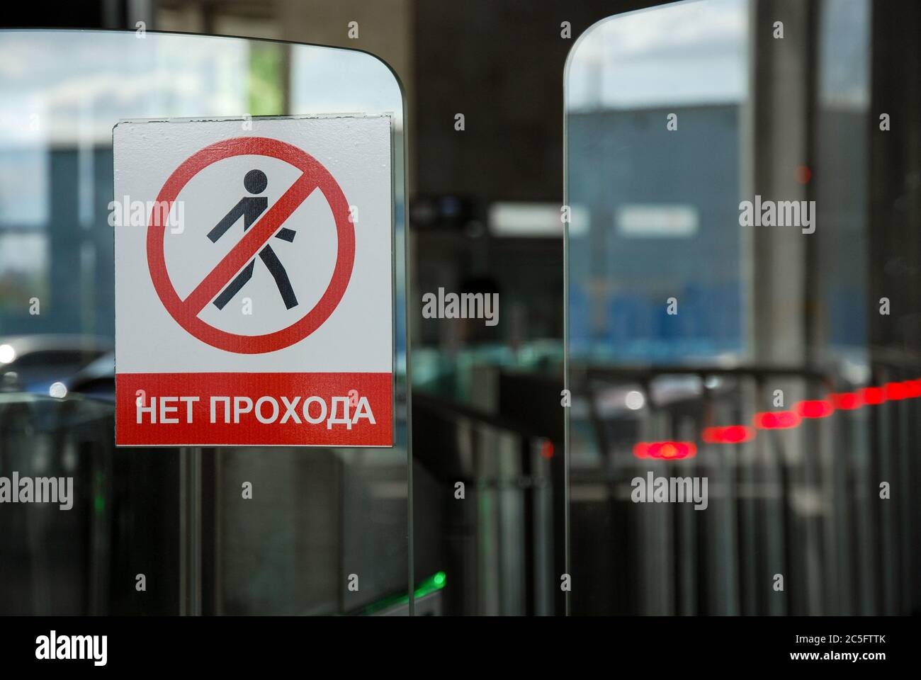 No entry sign and inscription in russian on glass doors of metro ...