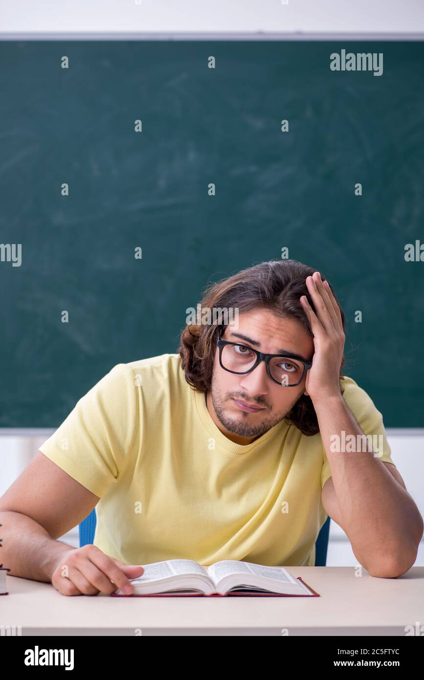 Young geography teacher in front of blackboard Stock Photo - Alamy