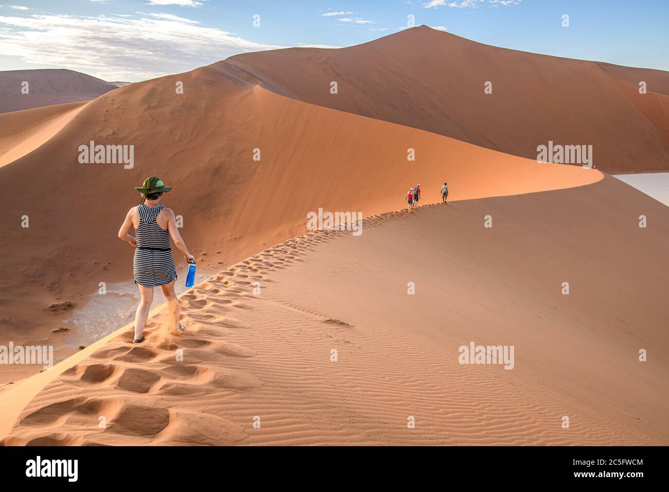 Hikers Hiking Through Sand Dunes in Sossusvlei , Namib-Naukluft National Park , Namibia Stock ...