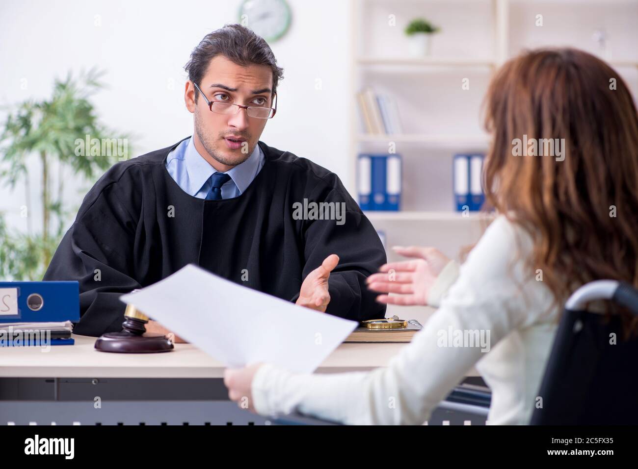 Injured woman and judge in the courtroom Stock Photo - Alamy