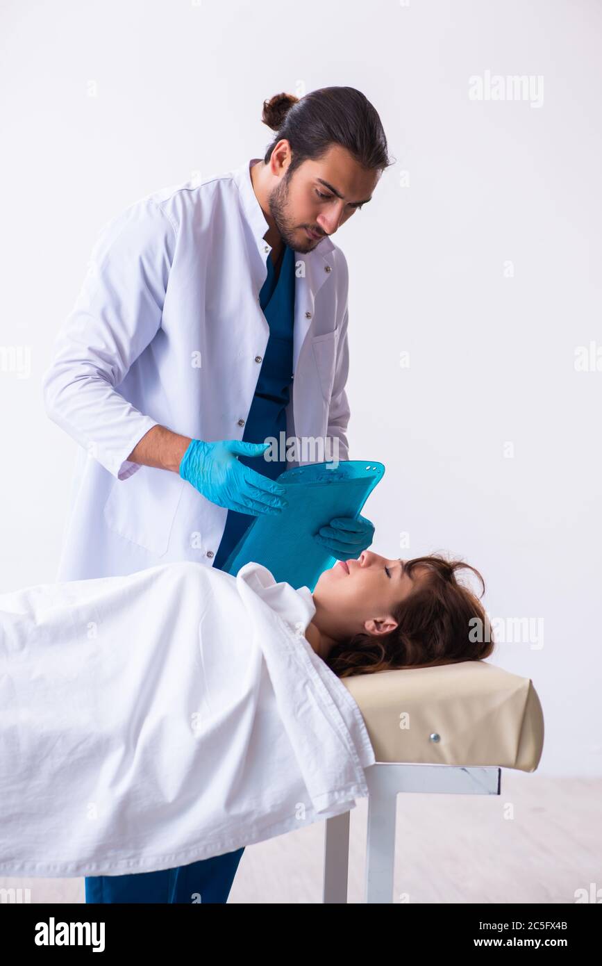 Police coroner examining dead body in morgue Stock Photo - Alamy