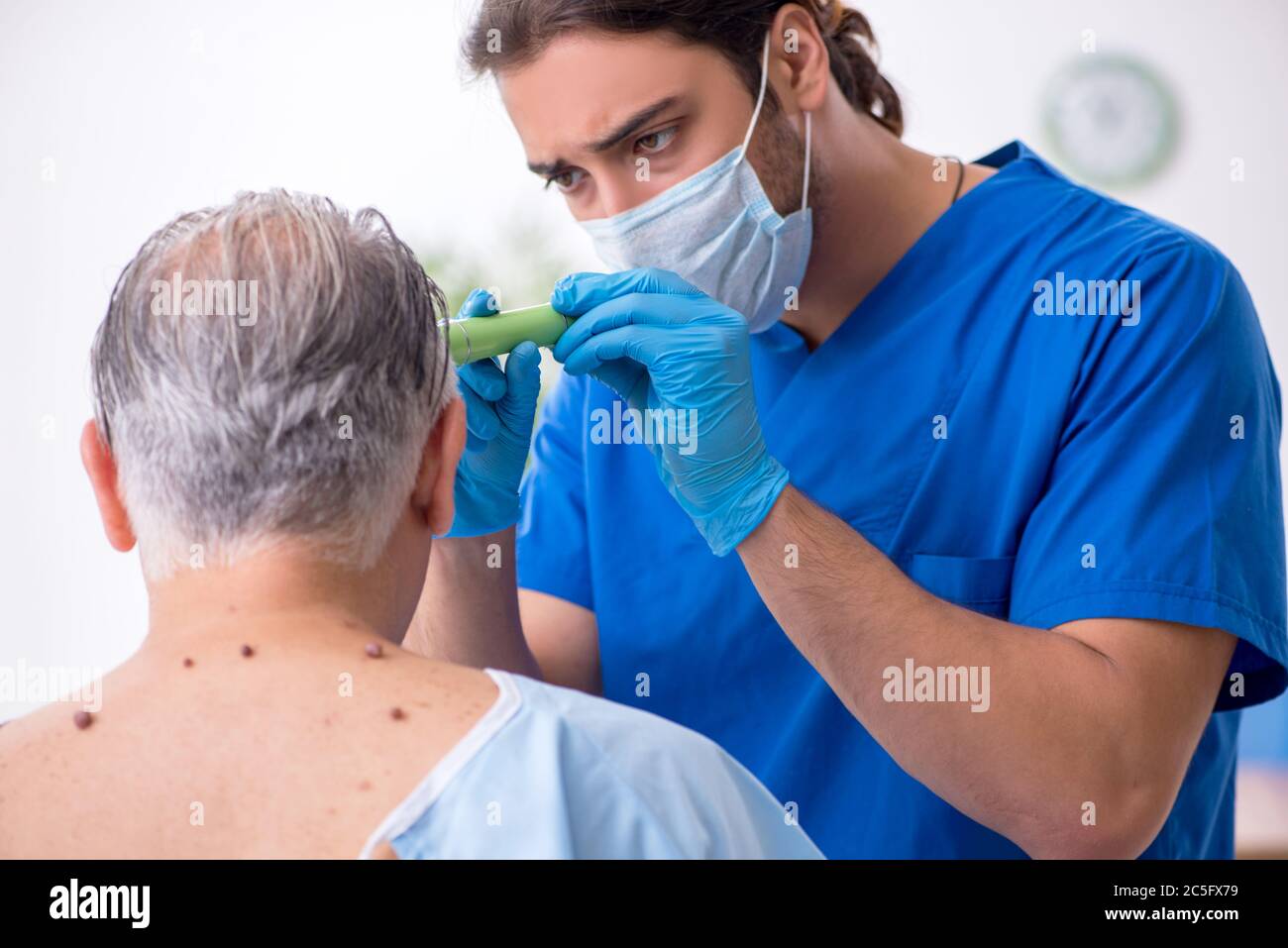 Old man visiting male doctor dermatologist Stock Photo - Alamy