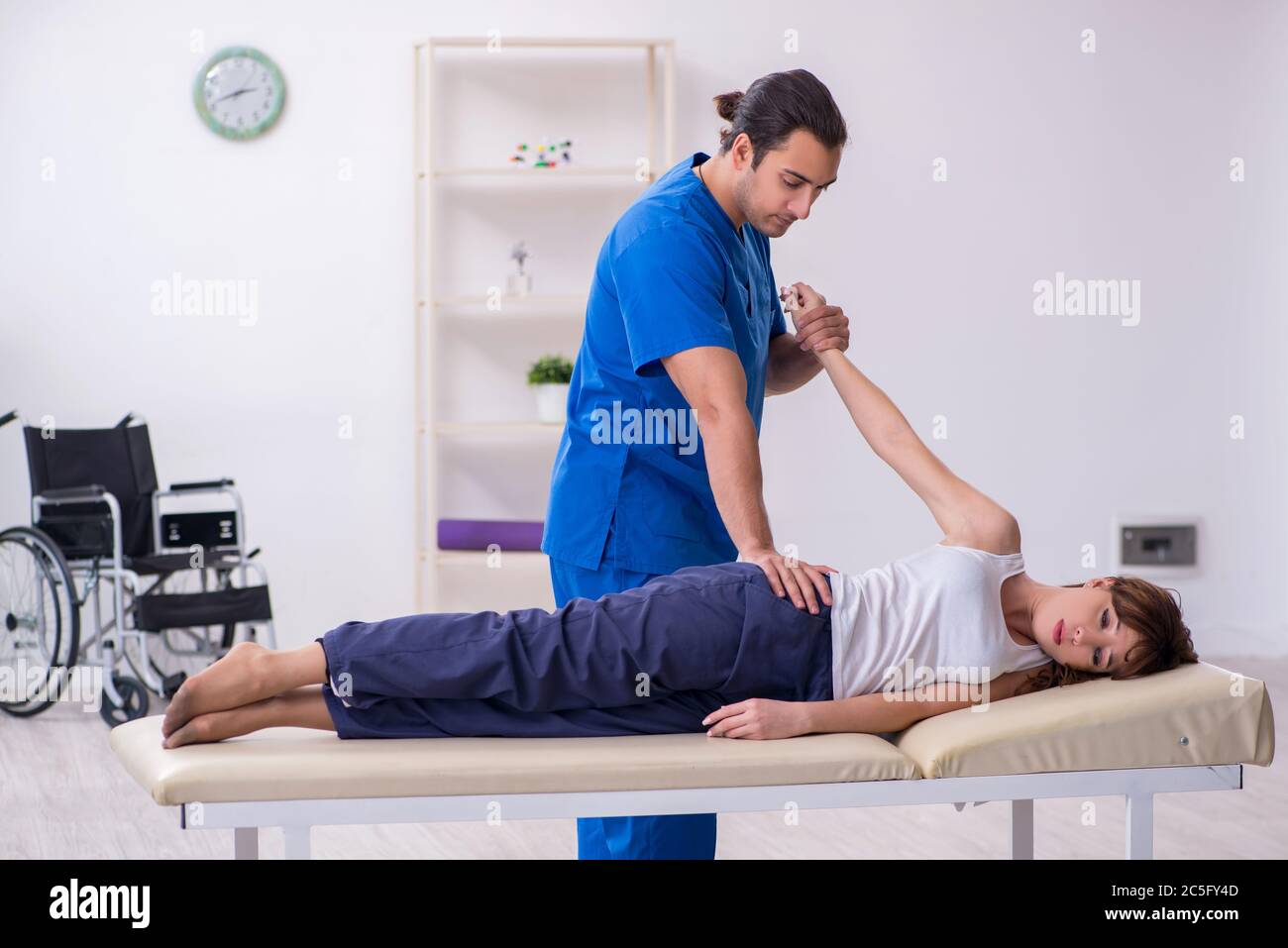 Injured woman visiting male doctor osteopath Stock Photo - Alamy