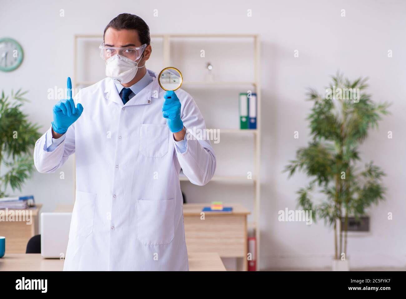 Young doctor virologist in the office Stock Photo - Alamy