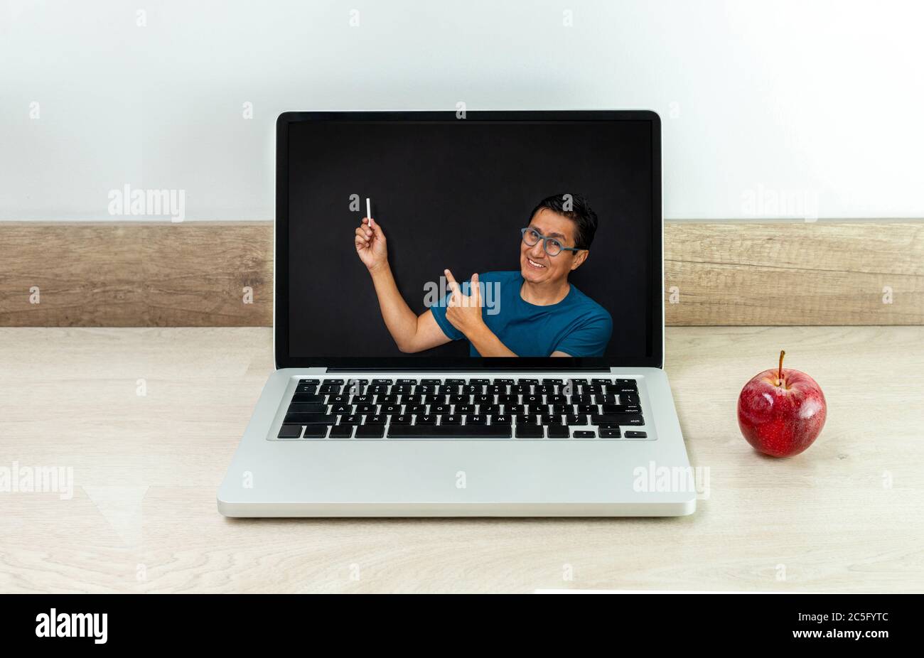 Teacher giving a class in front of a blackboard on the screen of a ...