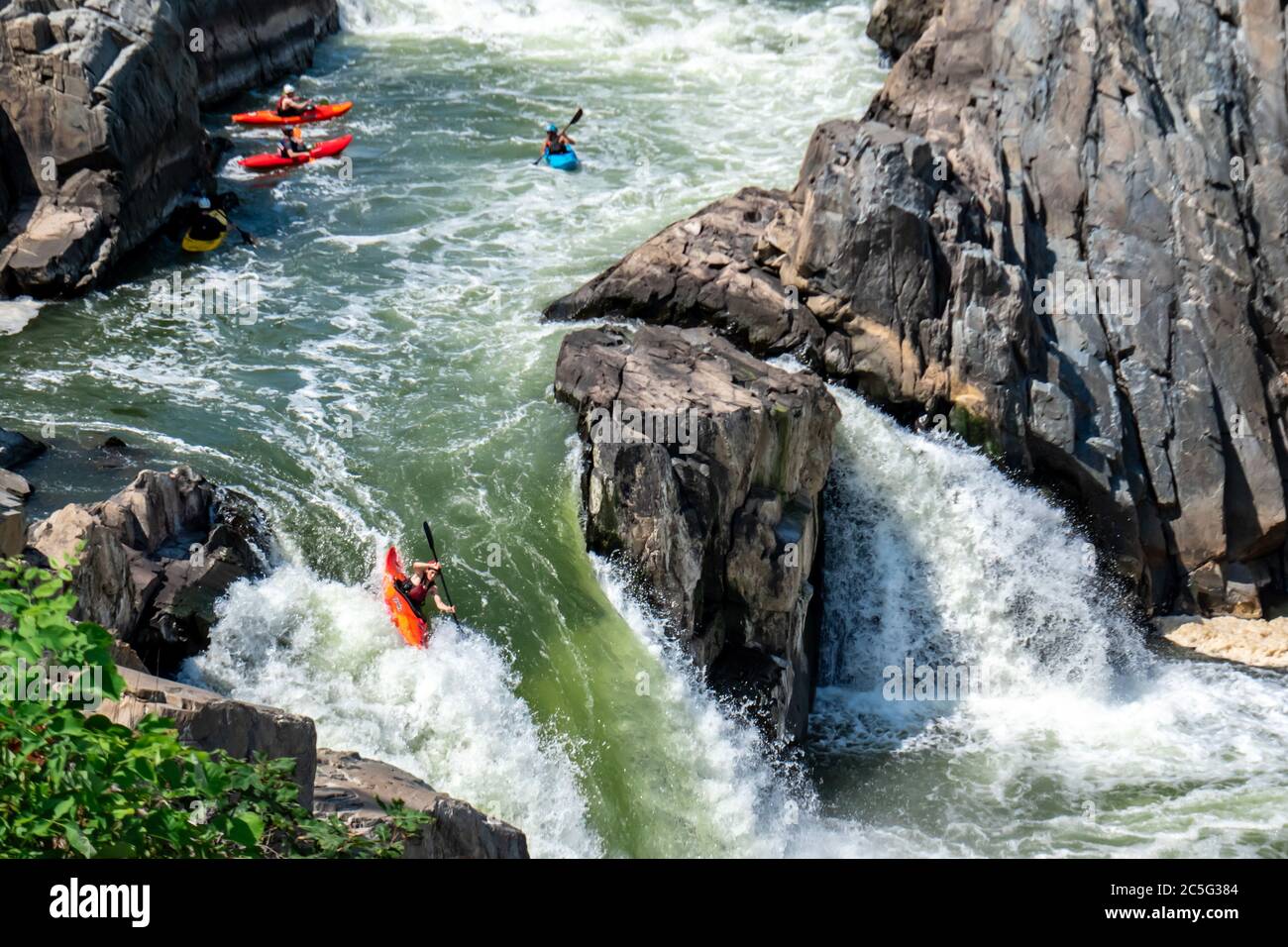 Brave river enthusiasts paddle their kayaks through the Potomac River ...