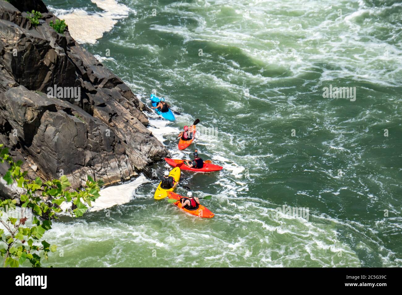 Brave river enthusiasts paddle their kayaks through the Potomac River ...