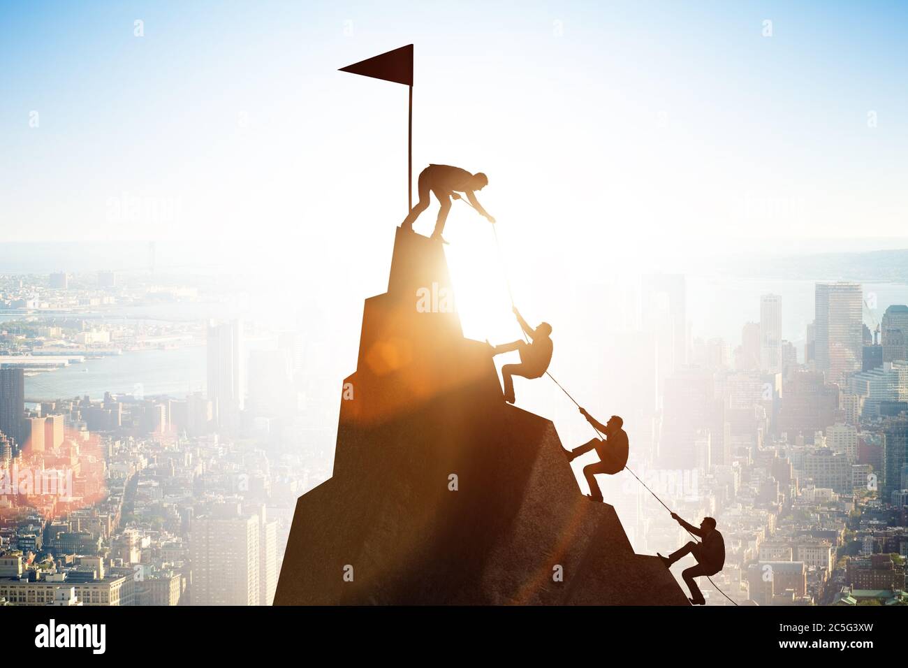 Concept of teamwork with team climbing mountain Stock Photo - Alamy