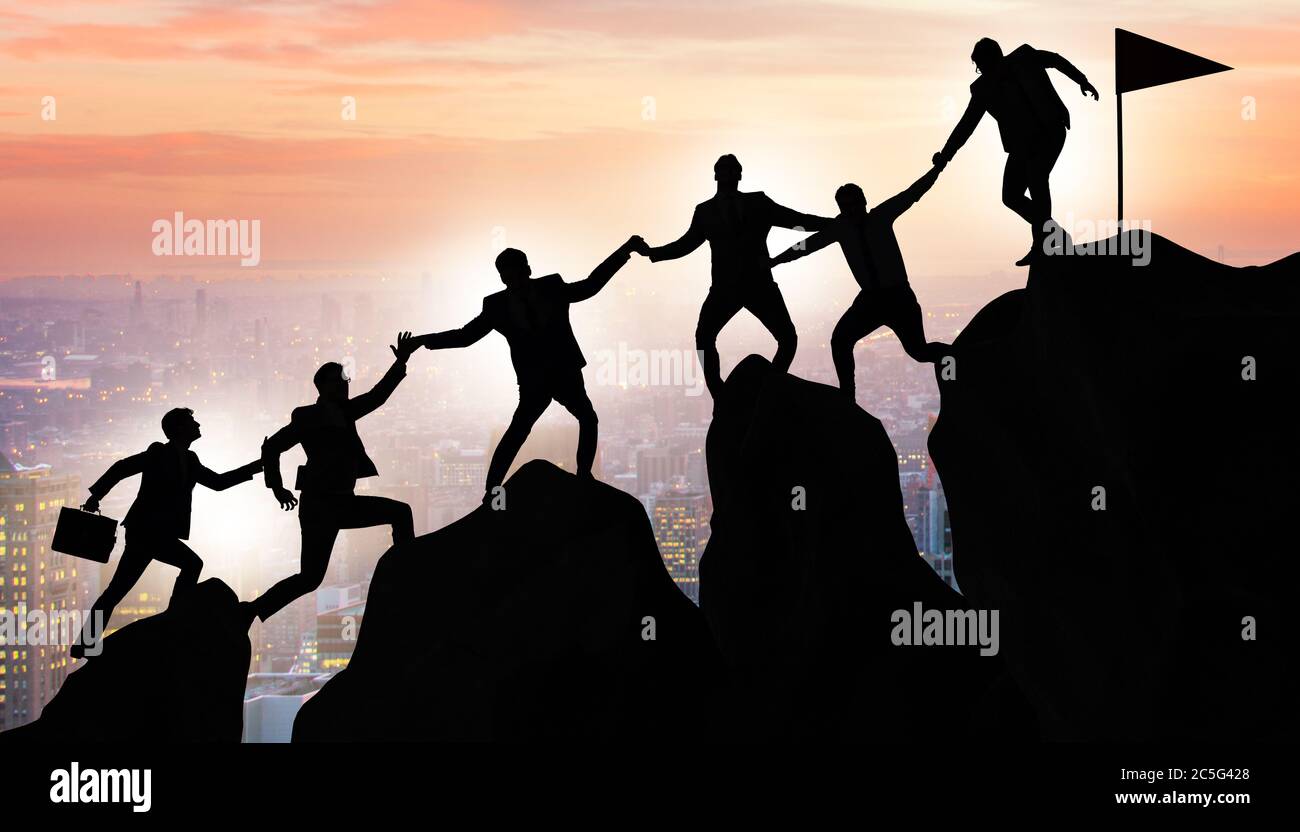 Concept of teamwork with the team climbing mountain top Stock Photo - Alamy