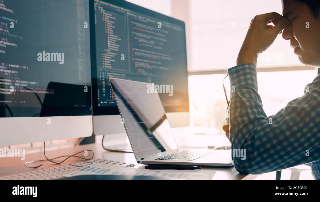 Male programmers are stressed at the office while working analyzing on ...