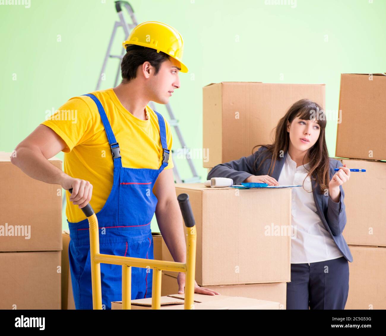 The woman boss and man contractor working with boxes delivery Stock ...