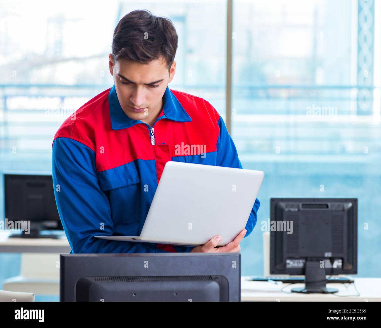 The computer technician repairing broken computer in workshop Stock ...