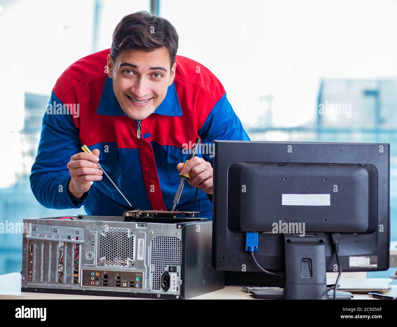 The computer technician repairing broken computer in workshop Stock ...