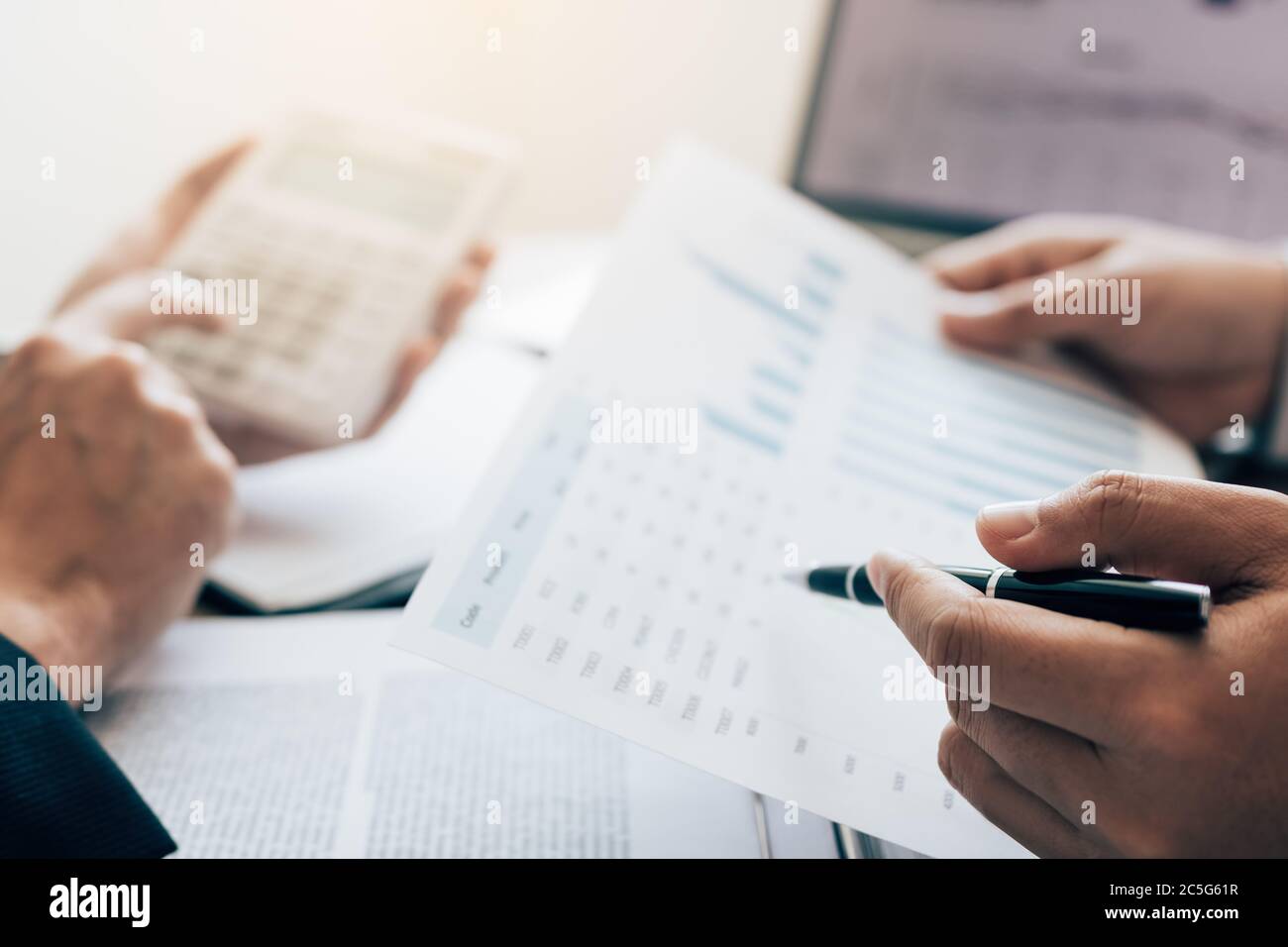 Business people pointing on statistic number result and analysis ...