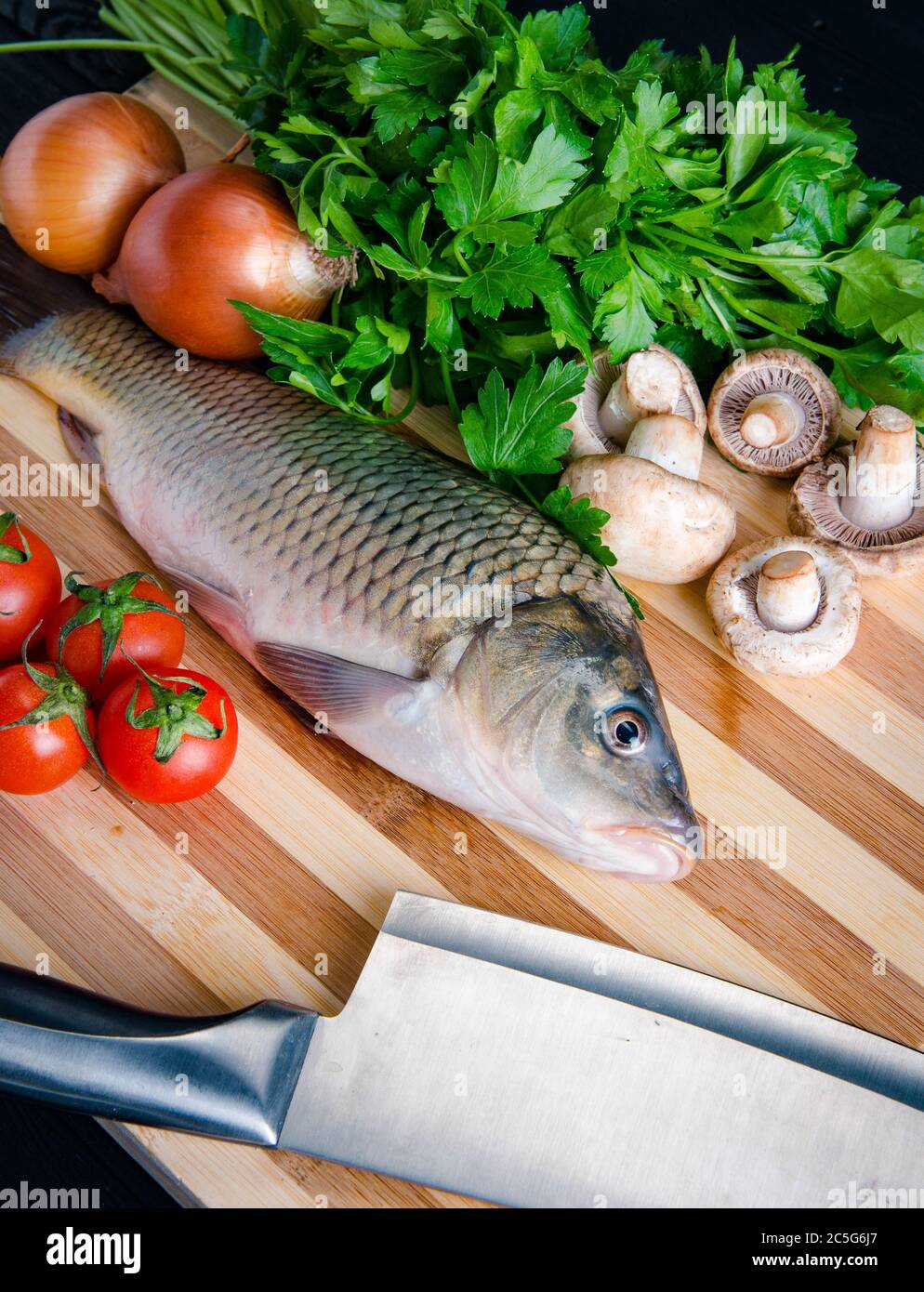 The uncooked fish on cutting board in meal preparation concept Stock ...