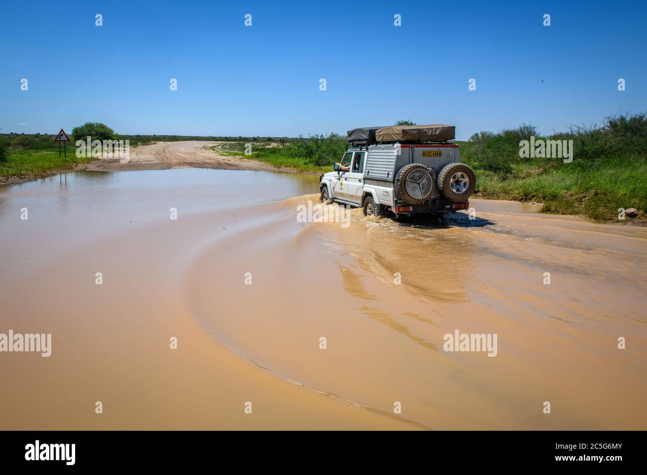 Driving Through a Puddle in the Kalahari Desert, Namibia Stock Photo ...
