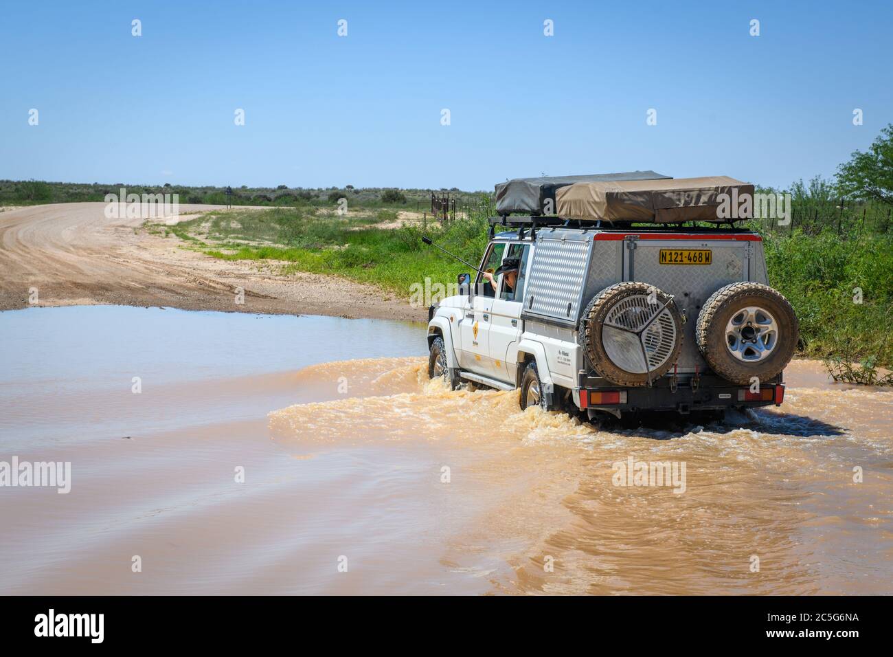Driving Through a Puddle in the Kalahari Desert, Namibia Stock Photo ...
