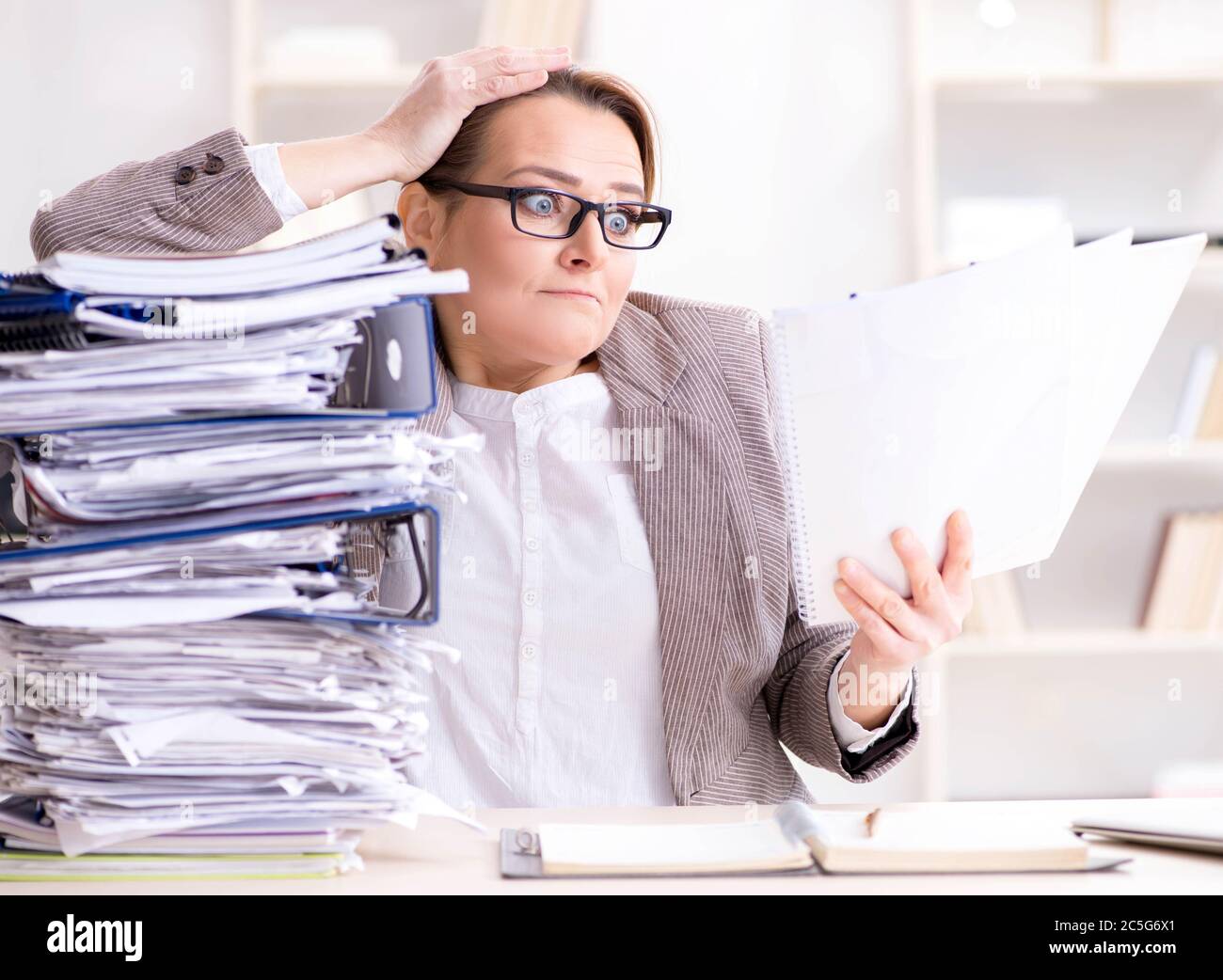 Businesswoman surprised stack folders desk hi-res stock photography and ...