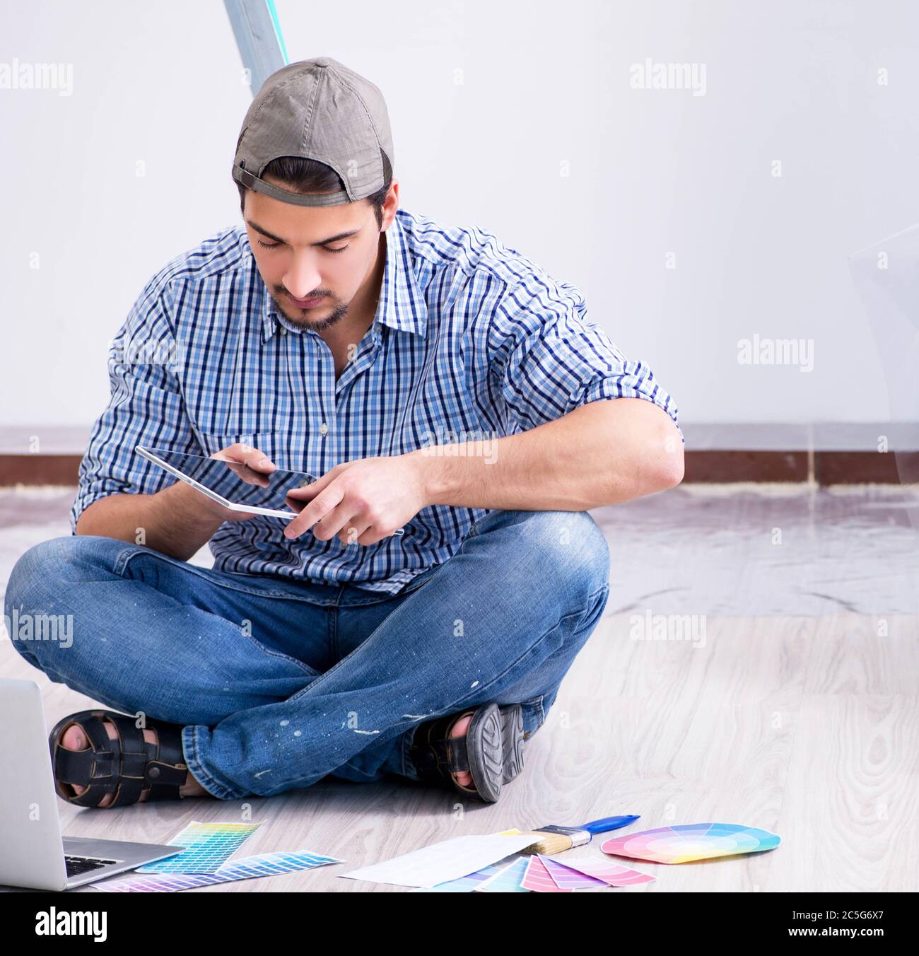 The young man contractor choosing color from rainbow Stock Photo - Alamy