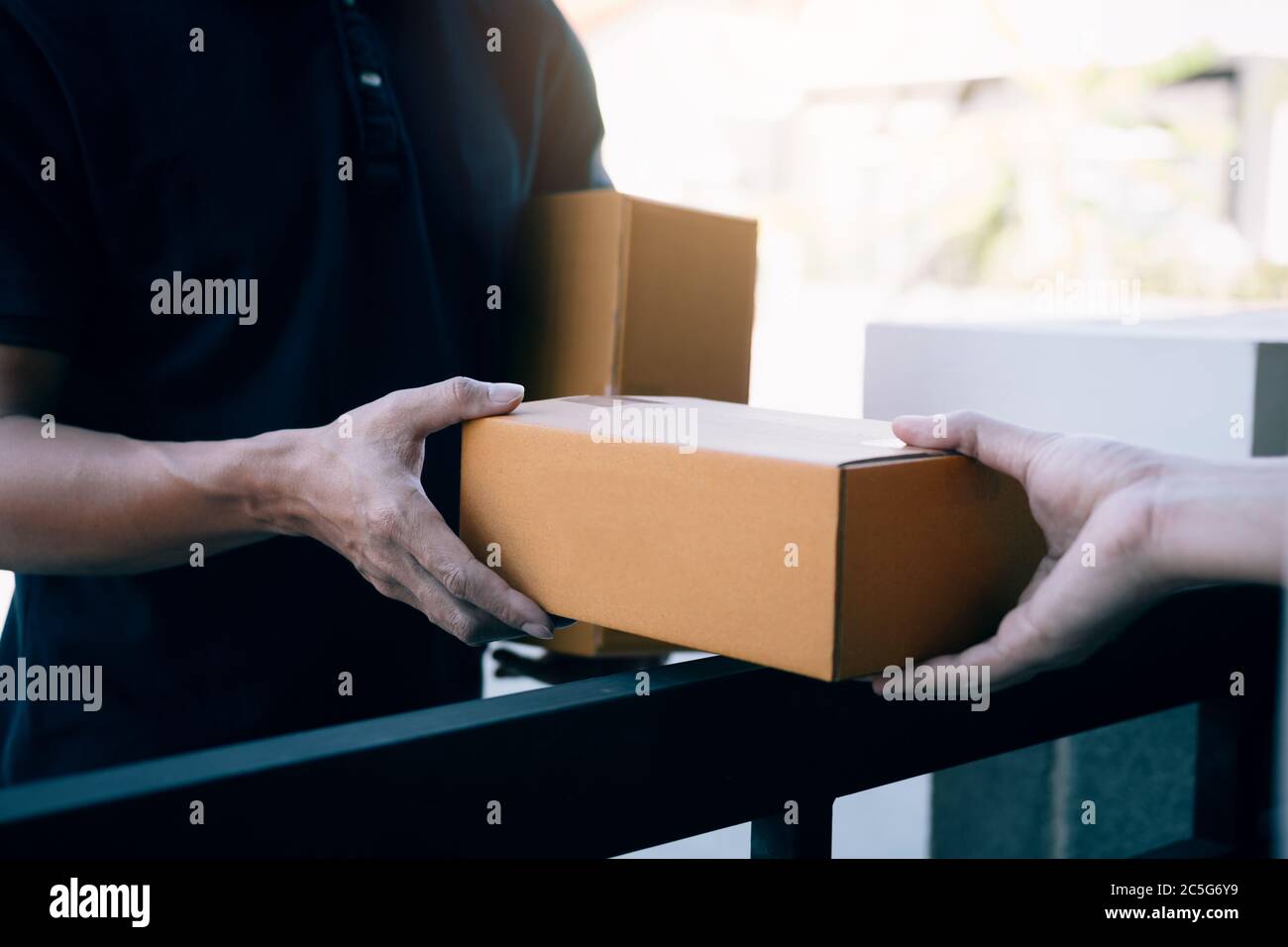 Close up of hands cargo staff are delivering cardboard boxes with ...